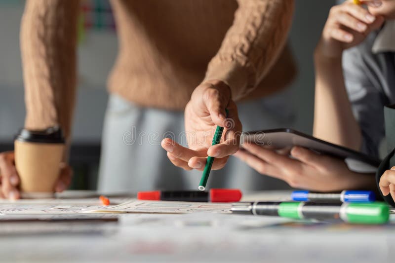 Team Discussing UX UI Strategies with Sketches and Digital Tools in a ...