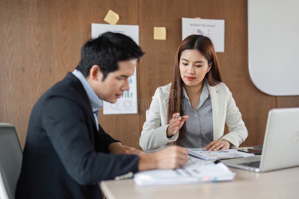 Team Discussion and Data Presentation. Professionals Collaborating on a Project while Reviewing ...