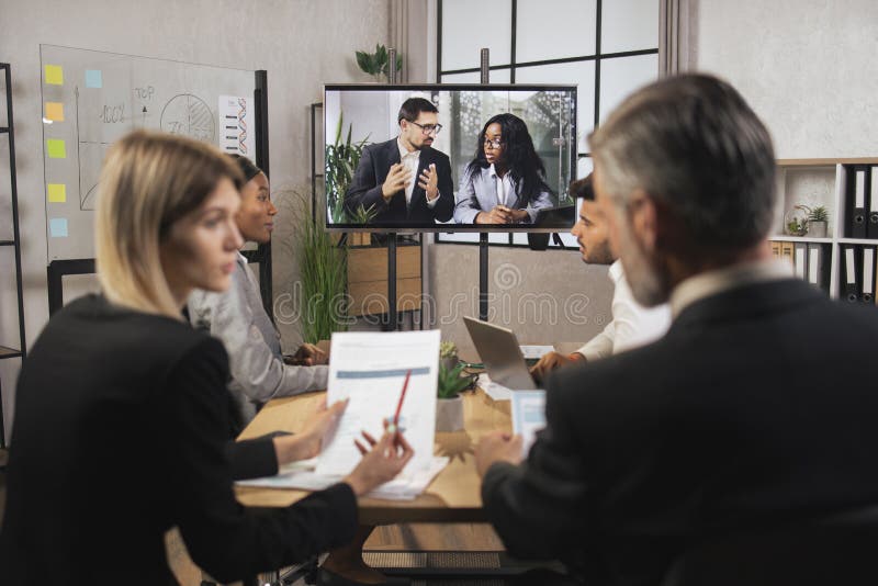Team Of Diverse Business People Looking At Screen During Video