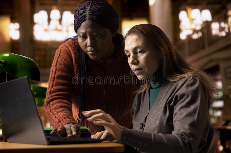 Team of Diverse Intellectual Senior Women Reading a Text Book Online ...