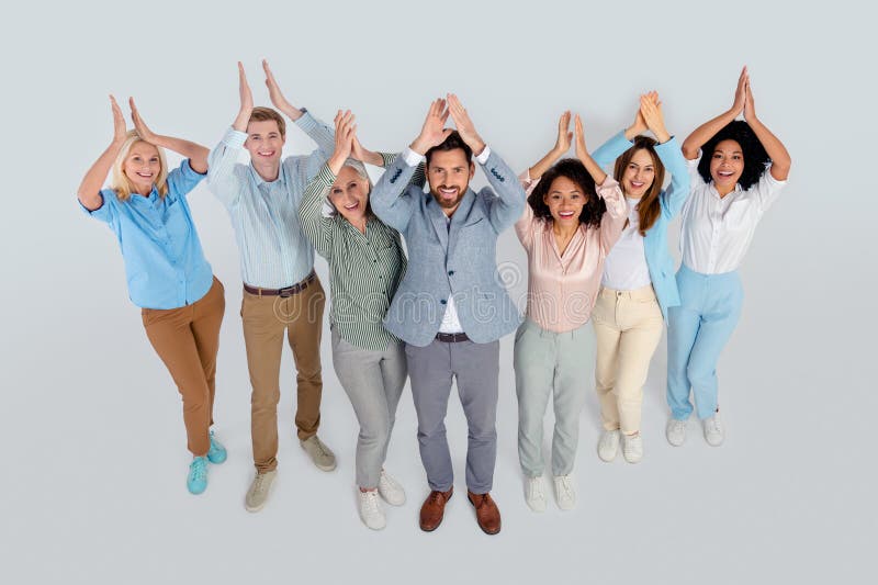 Diverse Group of Cheerful Professionals Standing Together on a Grey ...