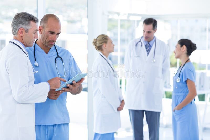 Team of Doctor Discussing Together Stock Photo - Image of clinic ...