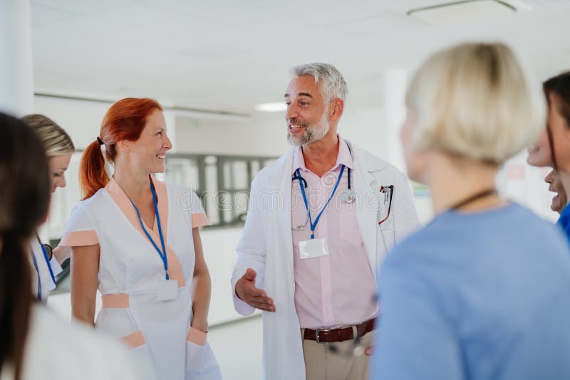 Team of Doctors Discussing Something at Hospital Corridor. Stock Image ...