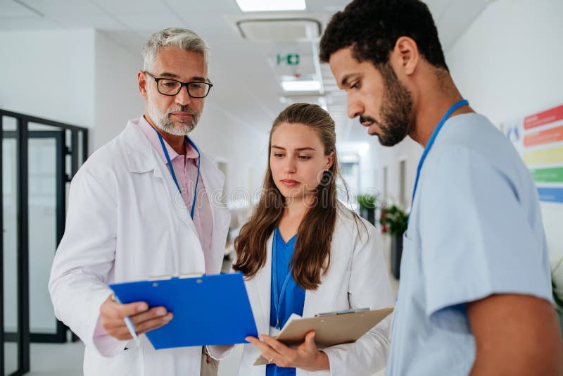 Team of Doctors Discussing Something at Hospital Corridor. Stock Image ...