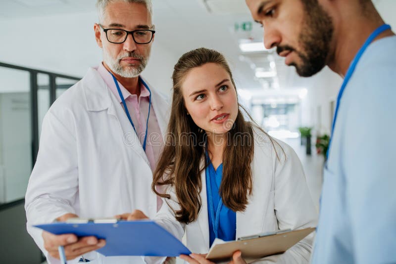Team of Doctors Discussing Something at Hospital Corridor. Stock Image ...