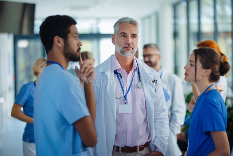 Team of Doctors Discussing Something at Hospital Corridor. Stock Image ...