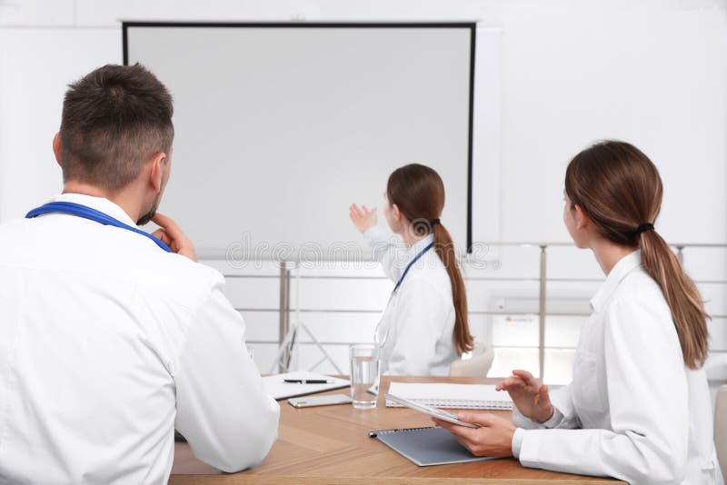 Team of Doctors Looking at Projection Screen Stock Photo - Image of ...
