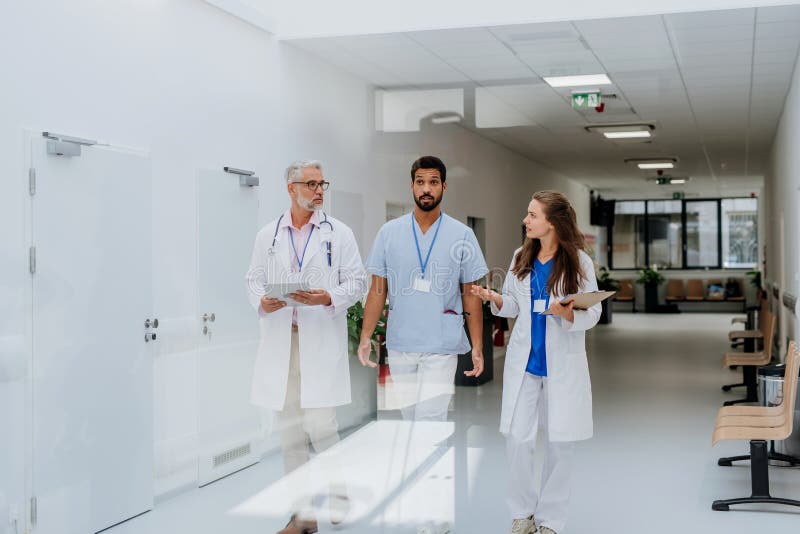 Team of Doctors Meeting at Hospital Corridor. Stock Image - Image of ...