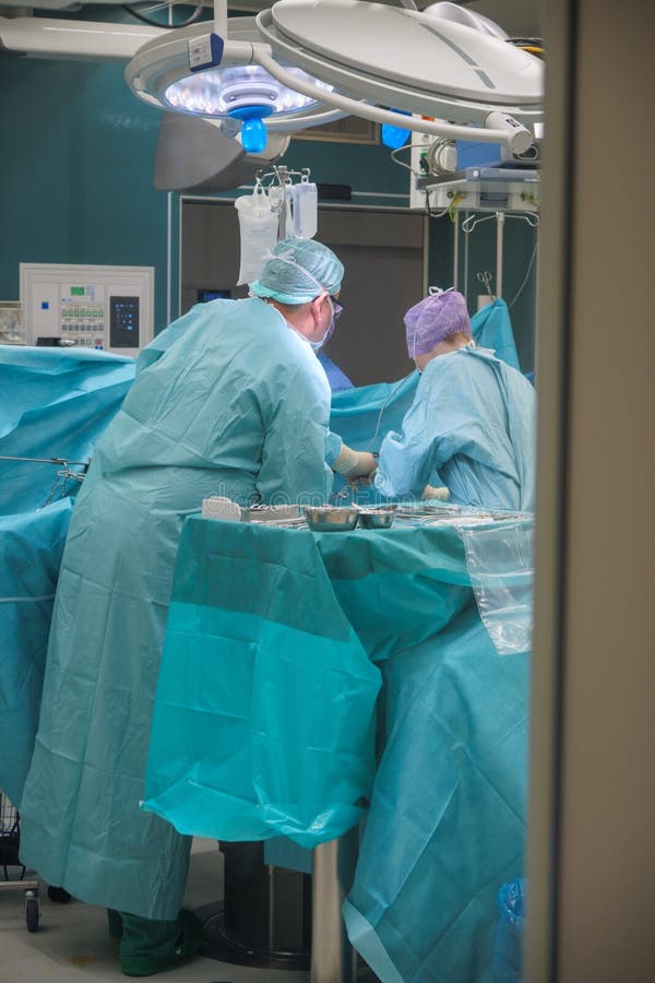 A Team of Doctors Performs an Operation in a Clinic Stock Photo - Image ...