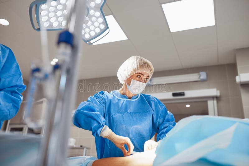 A Team of Doctors Performs an Operation. a Group of Surgeons at Work in ...