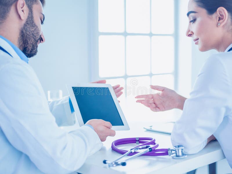 Team of Doctors Sitting at Table in Clinic Stock Photo - Image of ...