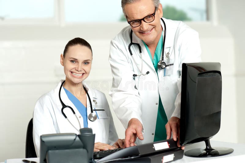 Team of Doctors Working on Computer Stock Photo - Image of happy ...