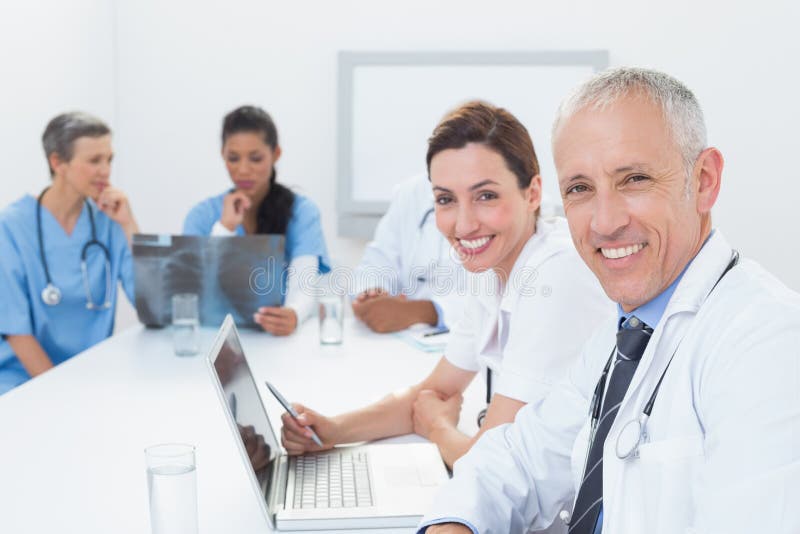 Team of Doctors Working on Laptop and Analyzing Xray Stock Image ...