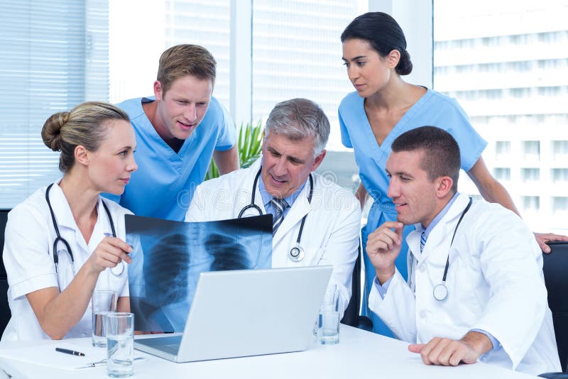 Team of Doctors Working on Laptop and Analyzing Xray Stock Image ...