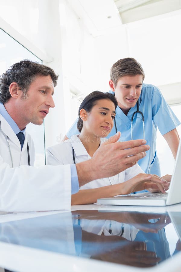 Team of Doctors Working on Laptop Computer Stock Photo - Image of ...