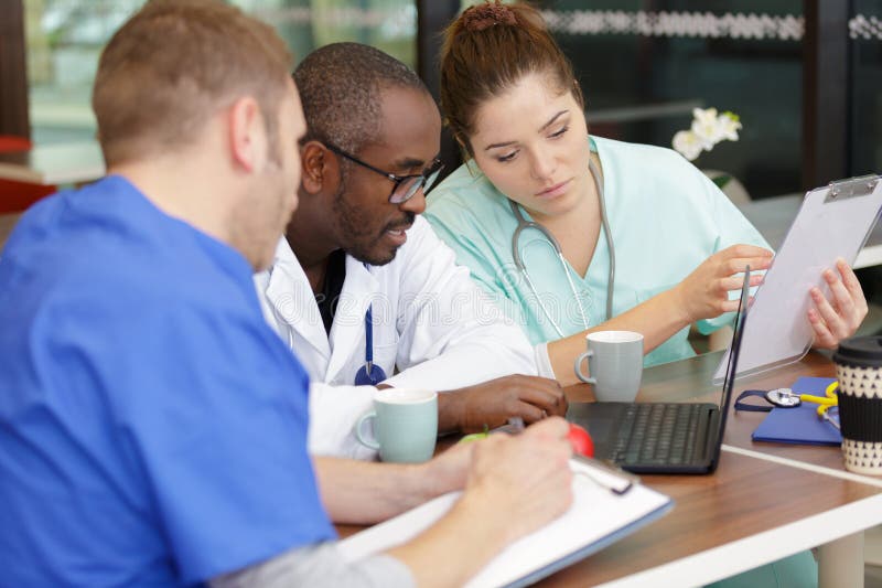 Team Doctors Working on Laptop in Medical Office Stock Image - Image of ...