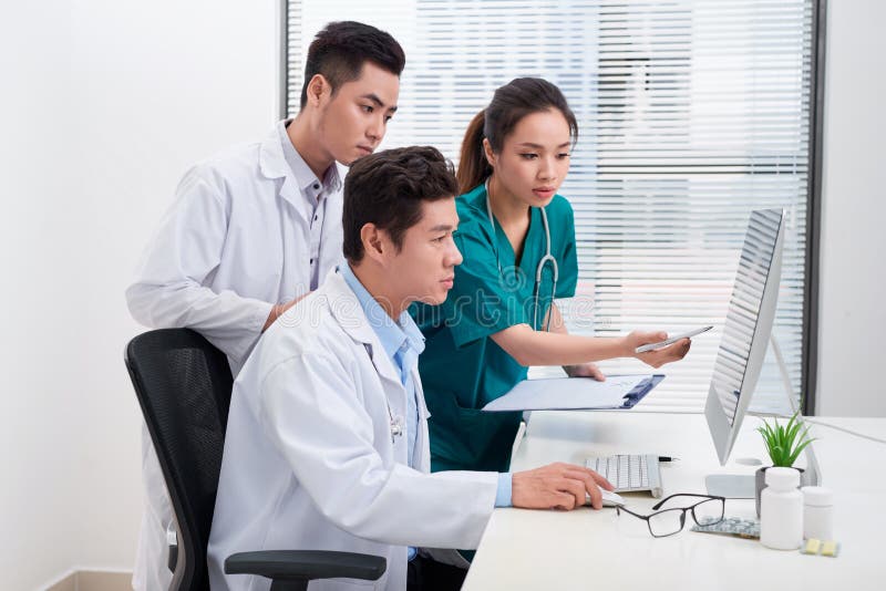 Team of Doctors Working Together Stock Photo - Image of tablet ...