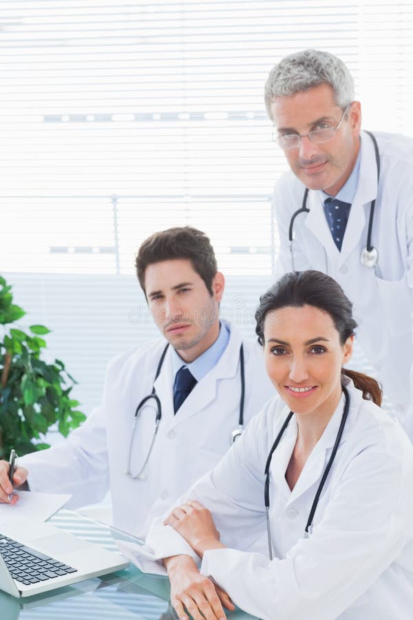 Team of Doctors Working Together Looking at Camera Stock Image - Image ...
