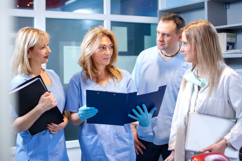 Team of Doctors Working Together on Patients File. Stock Image - Image ...