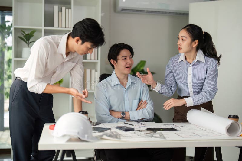 Team Dynamics and Idea Sharing. Professionals Engaged in a Lively Discussion about Building ...