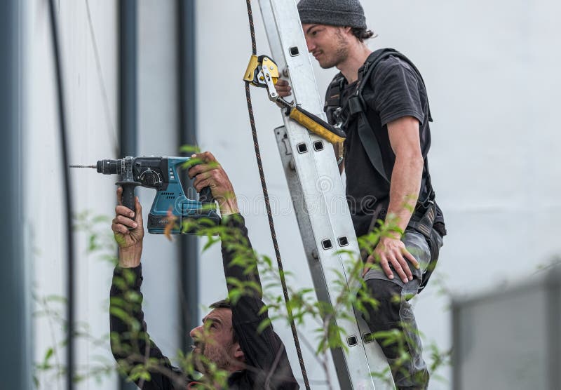Team of Electrical Engineers Install the Electrical Cables for the ...
