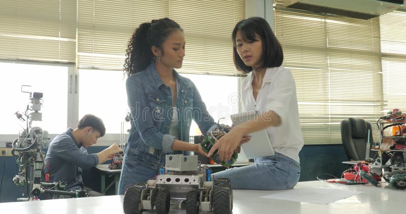 Team of Electronics Engineer Working Together, Collaborating on a Project To Build Robot. Stock ...