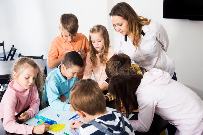 Team of Elementary Age Children Drawing Stock Photo - Image of indoors ...