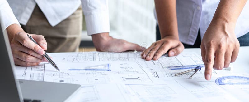 Team of Engineering or Architect Meeting and Discussing on Blueprint and Building Model while ...