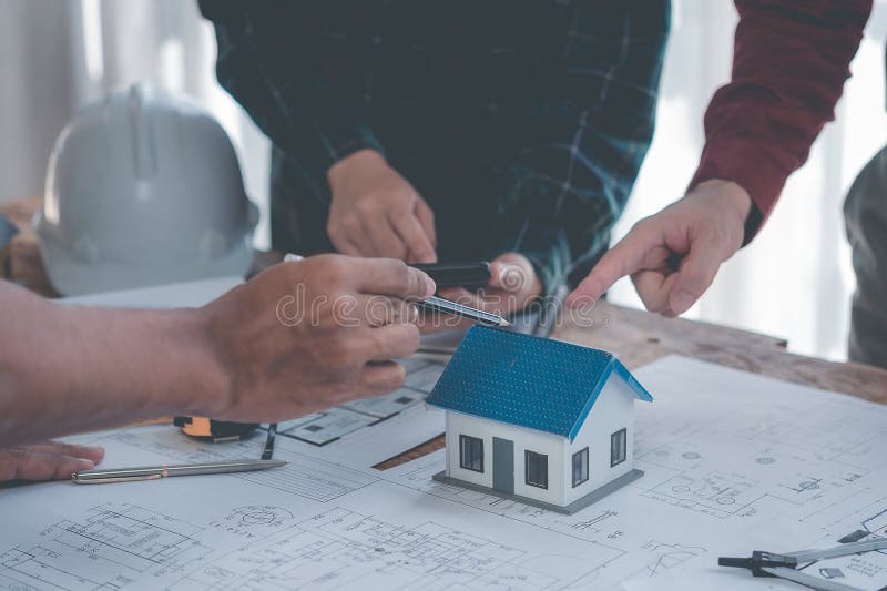 Team of Engineers and Architects Working, Planning, Measuring Diagrams ...