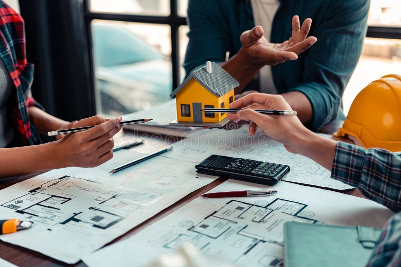 Team of Engineers and Architects Working, Planning, Measuring Diagrams ...