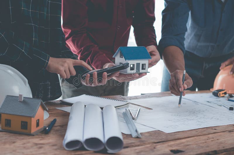 Team of Engineers and Architects Working, Planning, Measuring Diagrams ...