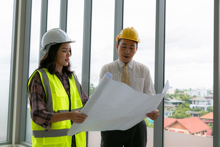 Team of Engineers Architects Working and Standing Around Table Working ...