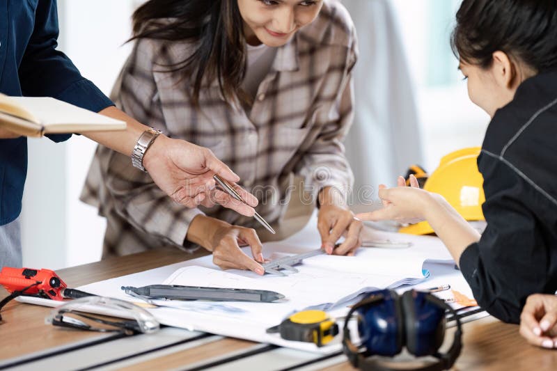 Team of Engineers Collaborating on Project Plans at Modern Workspace ...