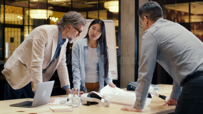 Team of Engineers Discussing Blueprint in Office Room Stock Image ...