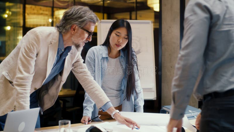 Team of Engineers Discussing Blueprint in Office Room Stock Image ...