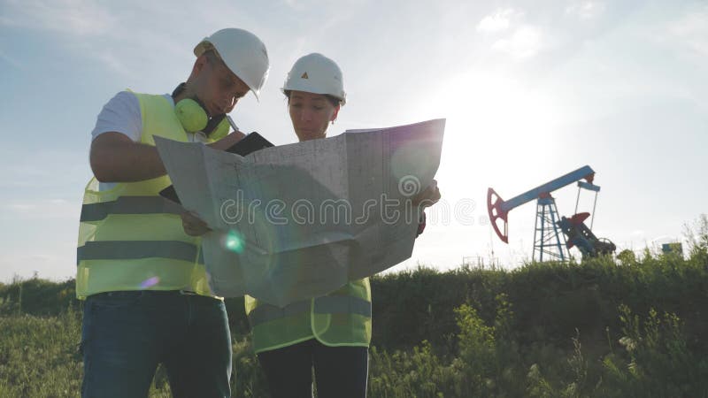 A Team Engineers Discussing the Maintenance of a Oil Pump Field ...