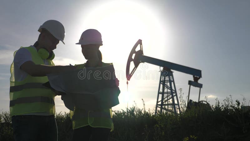 A Team Engineers Discussing the Maintenance of a Oil Pump Field ...