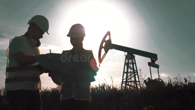 A Team Engineers Discussing the Maintenance of a Oil Pump Field ...