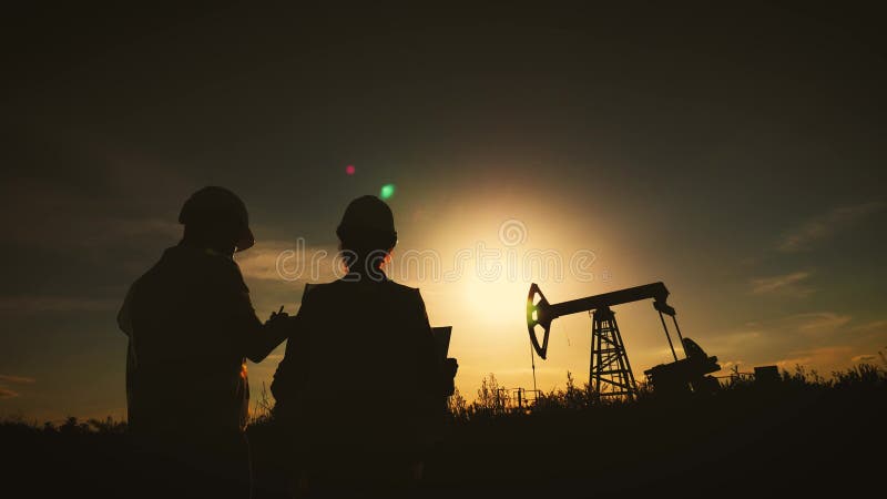 A Team Engineers Discussing the Maintenance of a Oil Pump Field ...