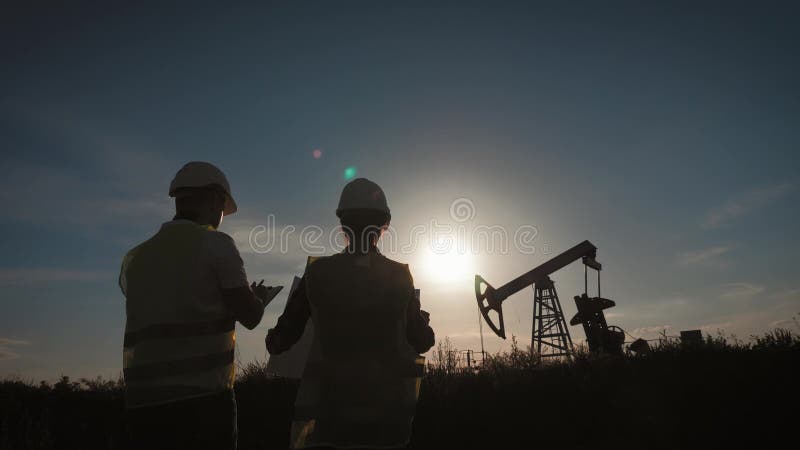A Team Engineers Discussing the Maintenance of a Oil Pump Field ...