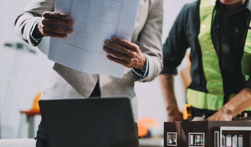 Team Engineers with Draft Plan of Building on Constructing Site ...