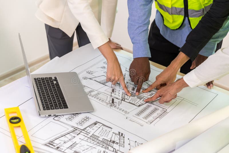 Team Engineers with Draft Plan of Building on Constructing Site. Stock ...