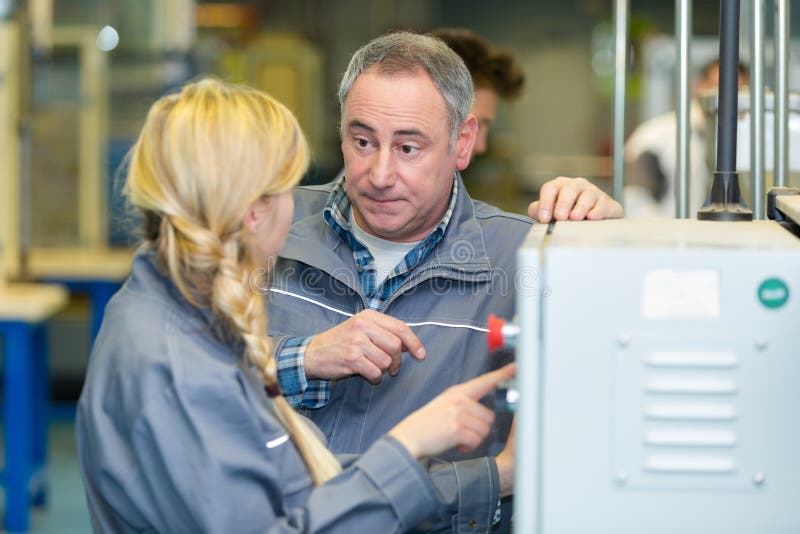 Discussion on Factory Floor Stock Photo - Image of inspector ...