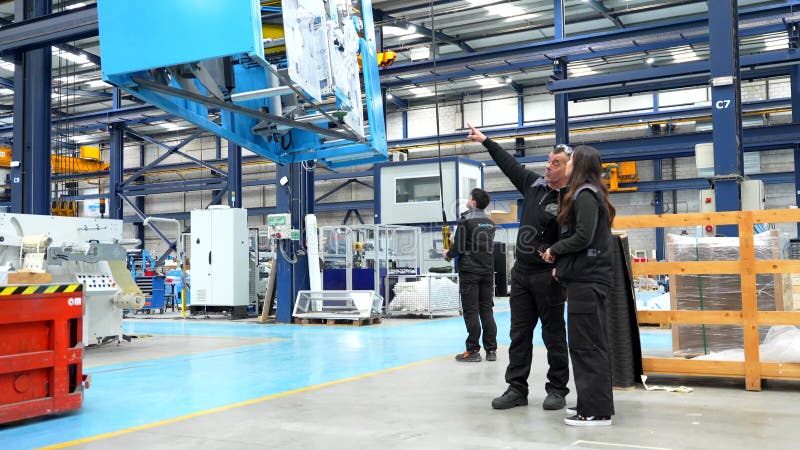Team of Engineers Lifting Heavy Machinery Using a Crane Stock Footage ...