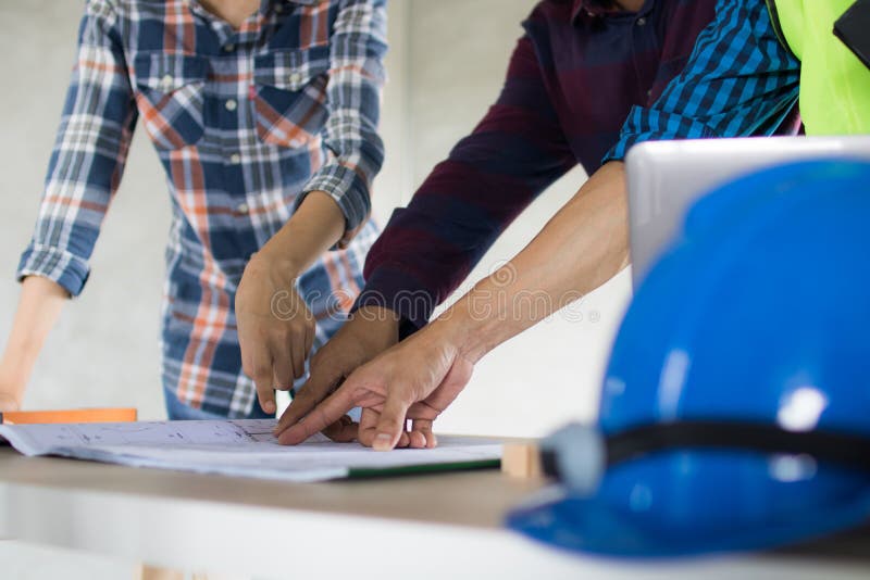 Team of Engineers Planing on Blue Print and Discuss about Construction ...