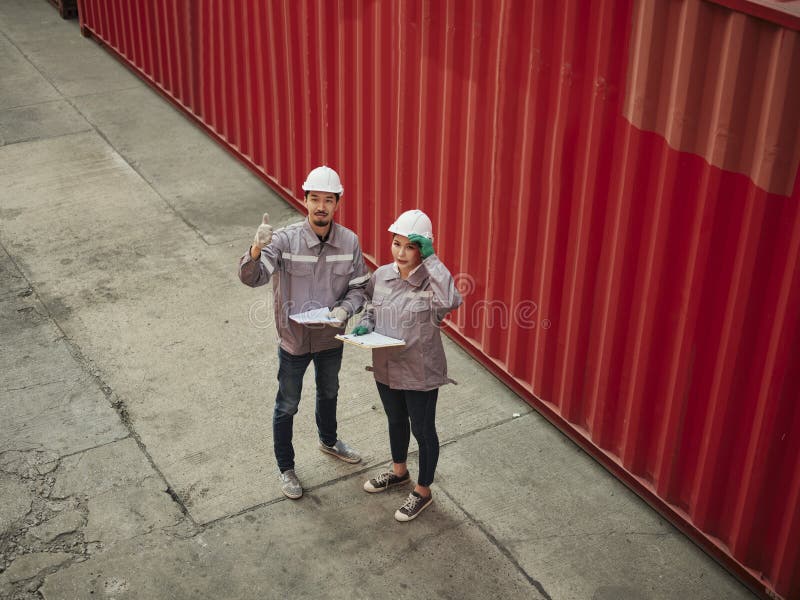 A Team of Engineers Showing Thumbs Up at the Container Cargo Stock ...