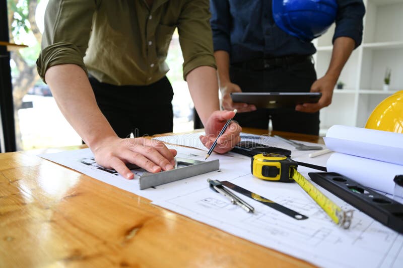 Team of Engineers Standing at Meeting Table, Discussing Construction ...