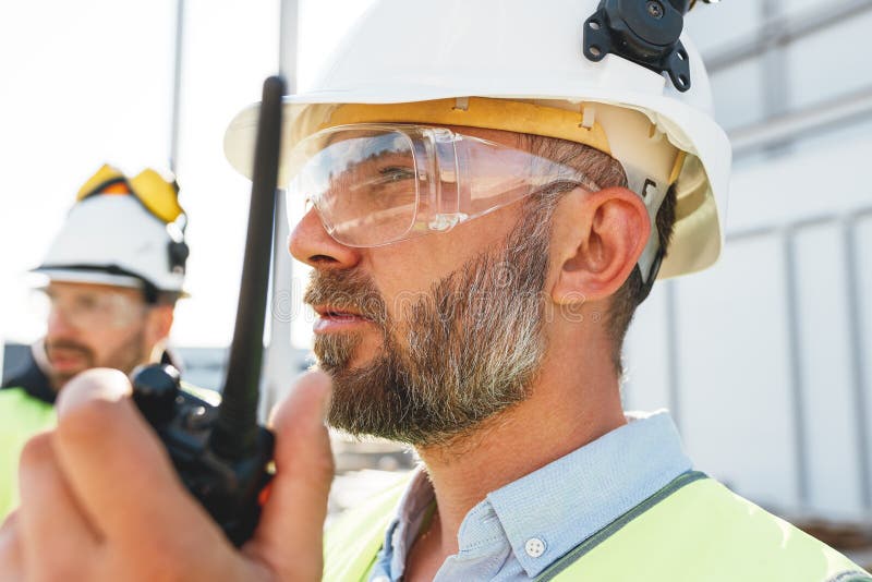 Team of Engineers Working on Construction Site. Two Bearded Builders ...