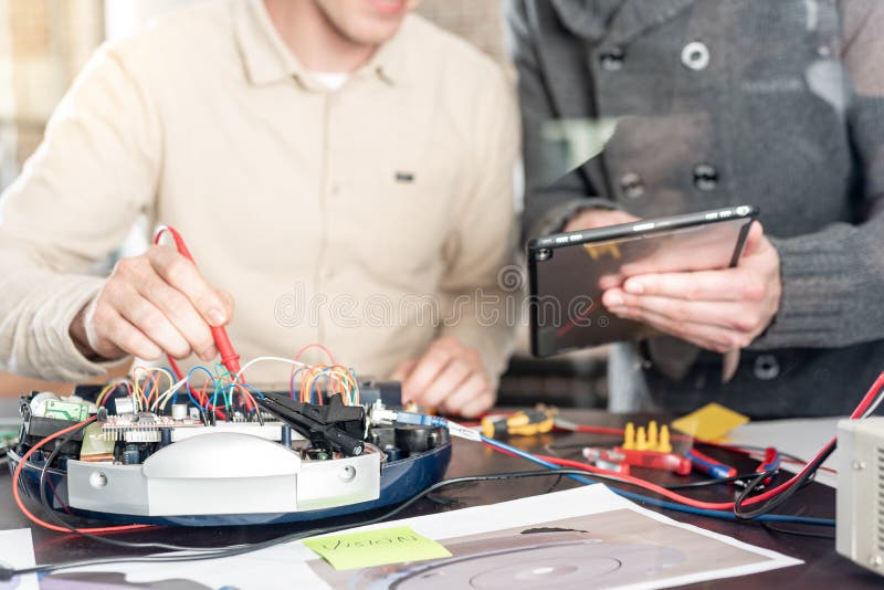 A Team of Engineers Working on a New Prototype Stock Photo - Image of ...
