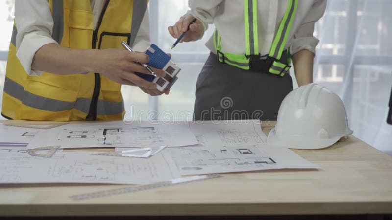 Team of Engineers Working Together on Blueprint Plan at Construction ...